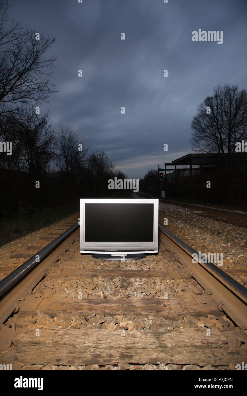 Flat panel television set on railroad tracks at night Stock Photo - Alamy