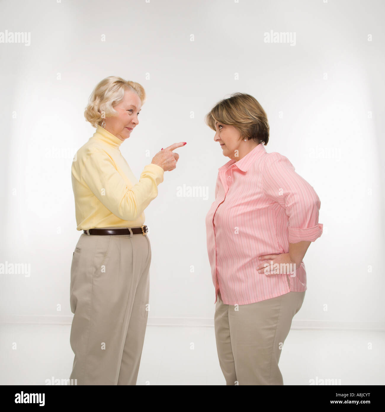 Caucasian senior woman and middle aged woman face to face arguing Stock ...