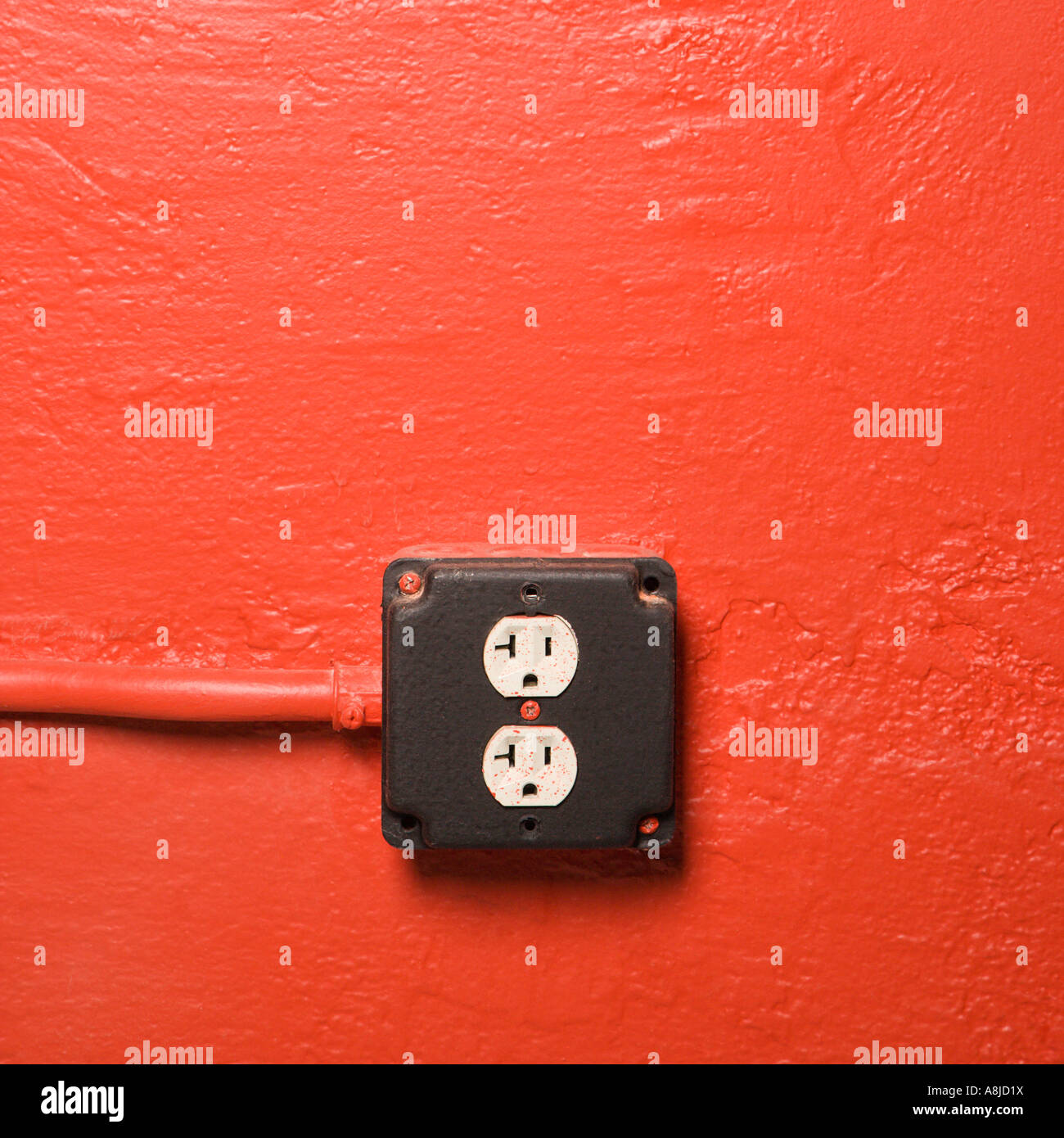 Red wall with electrical outlet Stock Photo - Alamy