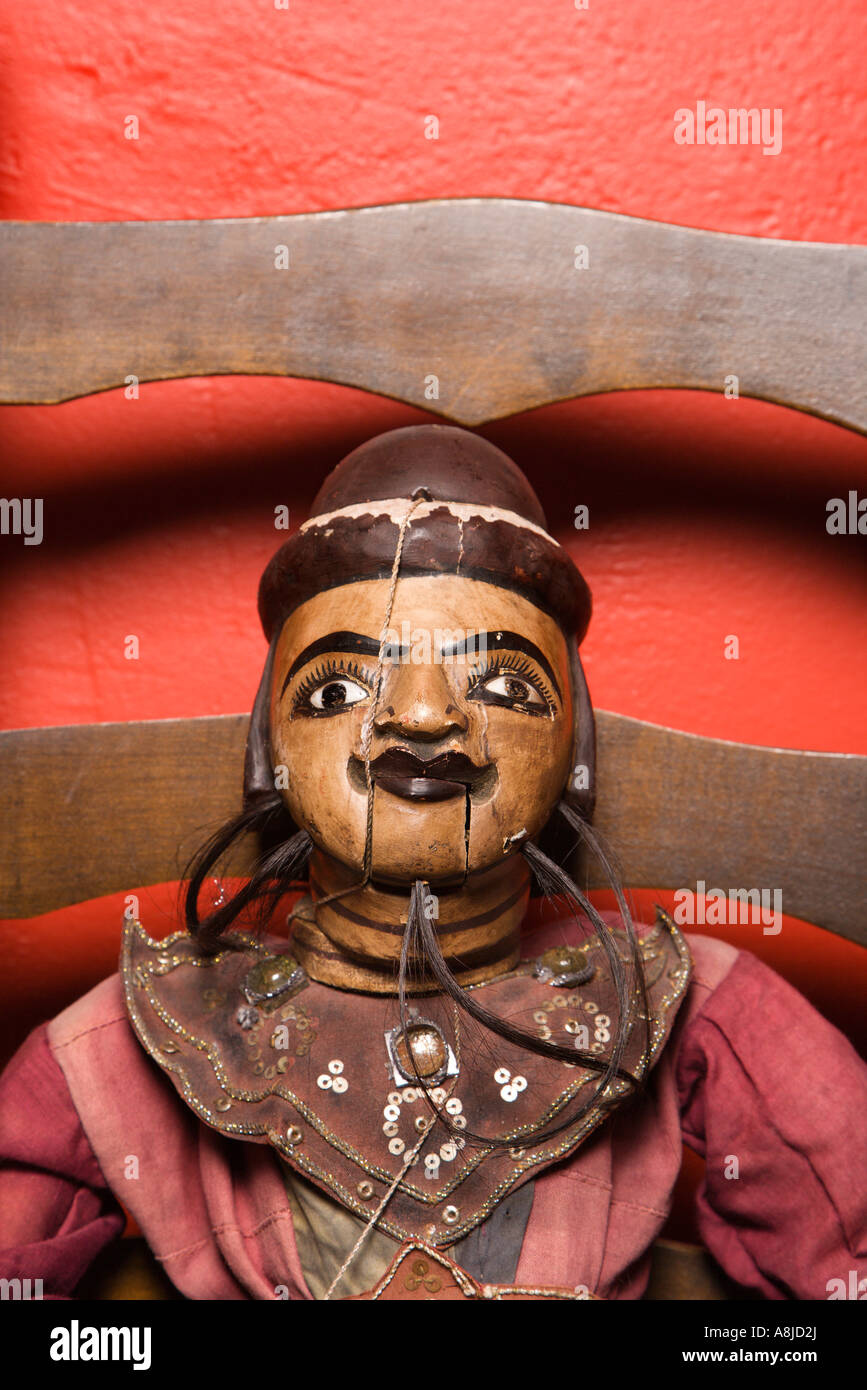 Close up of wooden puppet sitting on chair Stock Photo - Alamy