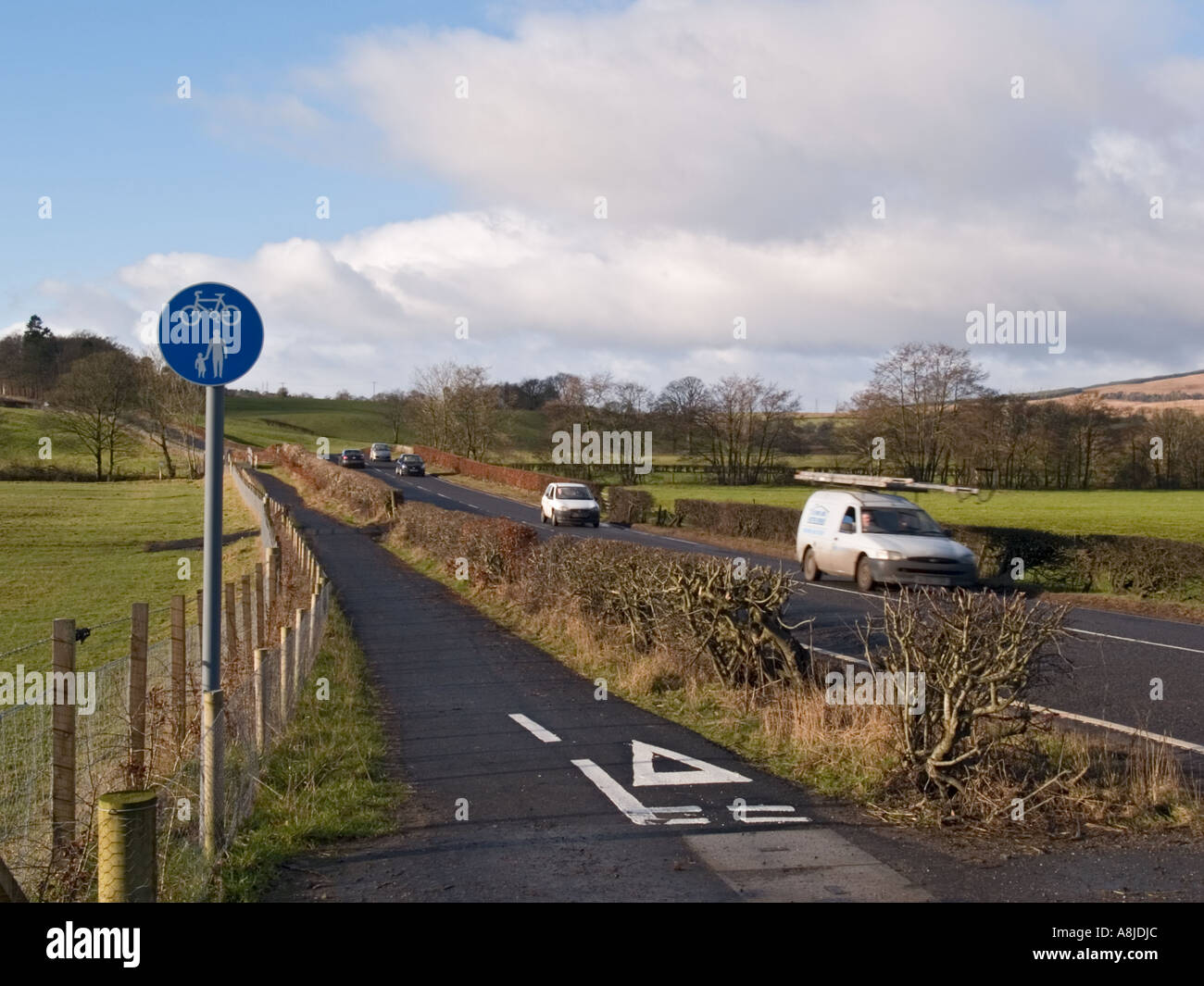 New cycle track and footpath beside busy rural B832 road with hedge ...