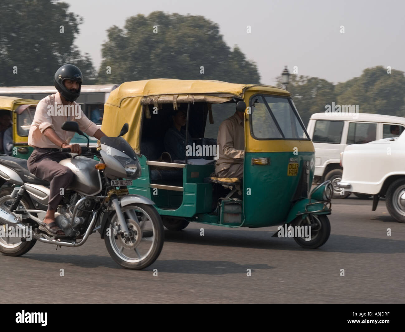 Traffic on busy road with green and yellow auto rickshaw fueled by ...