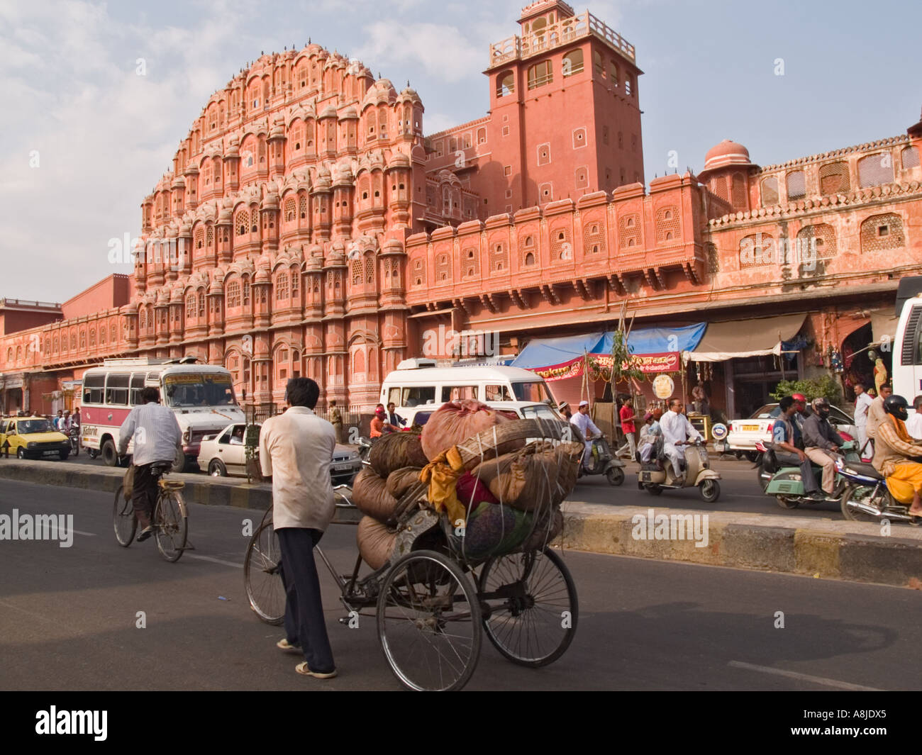 Hawa Mahal Bazaar with people and traffic passing Hawa Mahal Palace of ...
