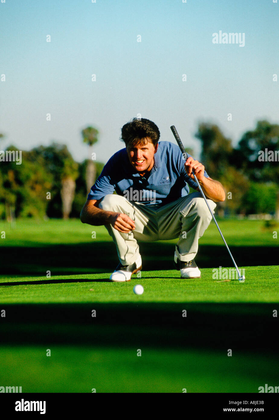 A golfer lining up the putt Stock Photo - Alamy