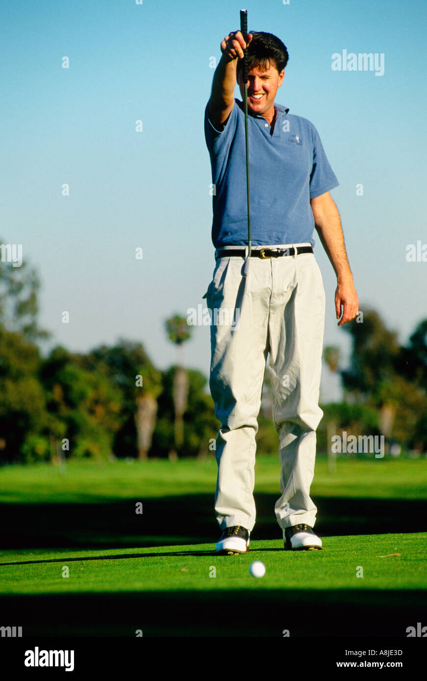 A golfer lining up the putt Stock Photo - Alamy