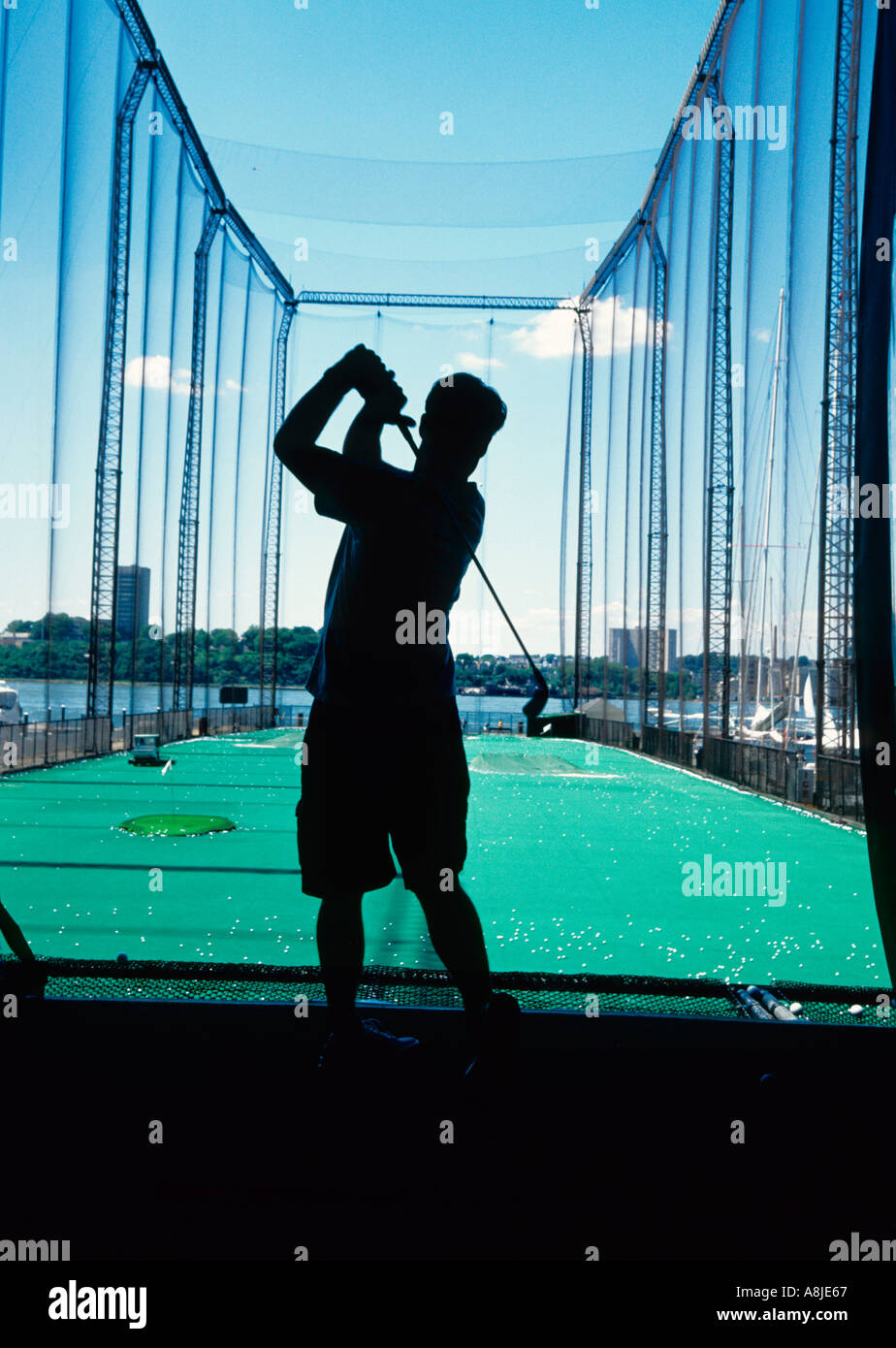 Golfer at a driving range Stock Photo - Alamy
