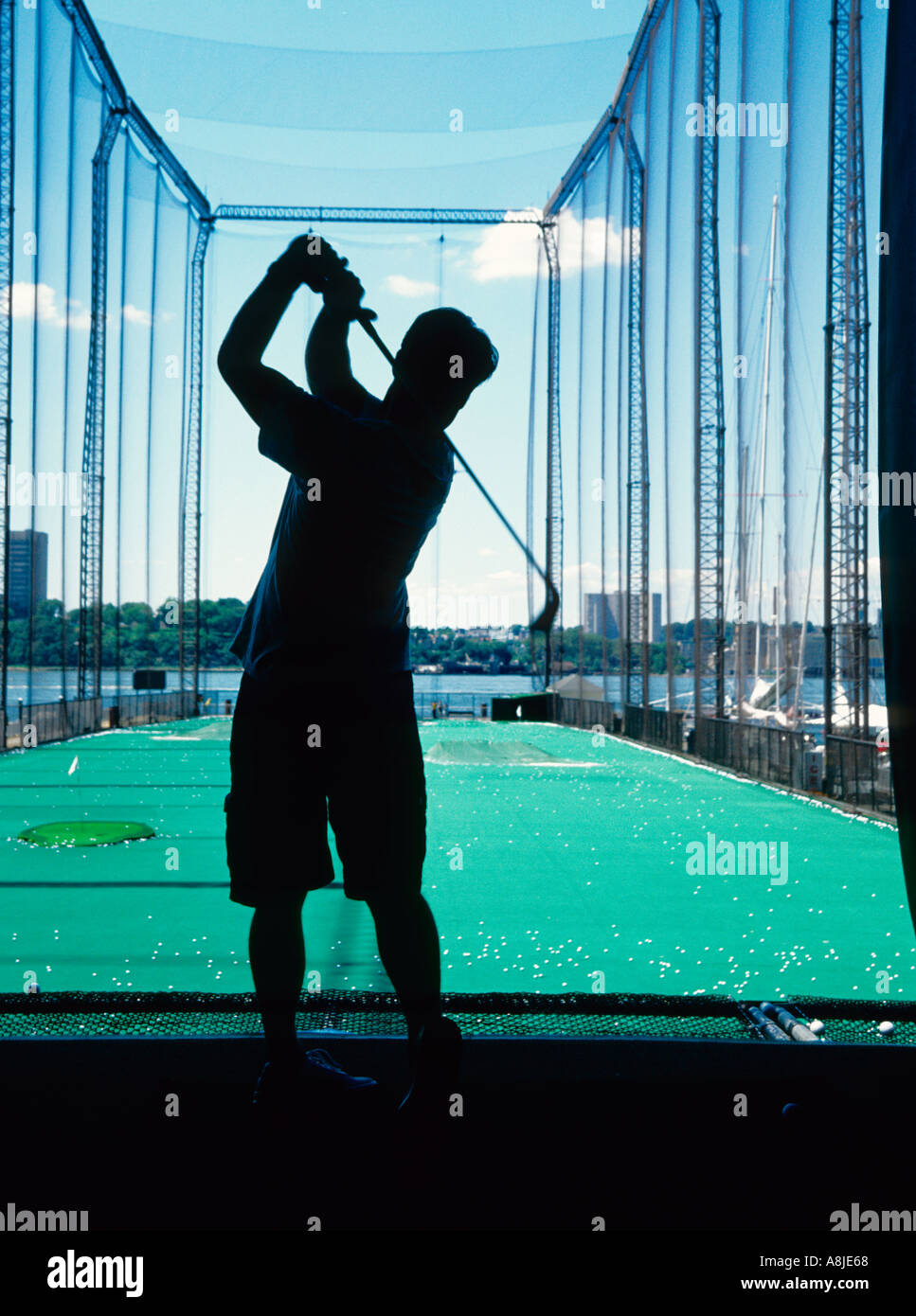 Golfer at a driving range Stock Photo - Alamy