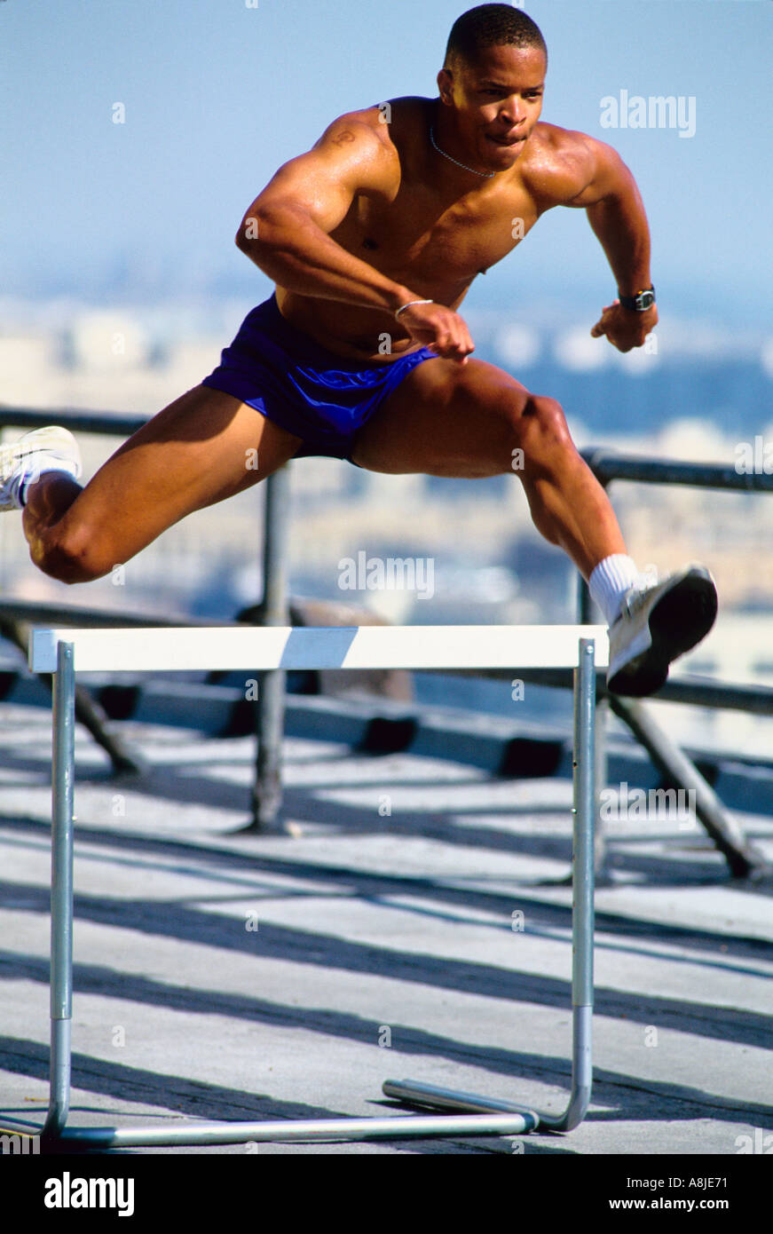 Runners jumping hurdles hi-res stock photography and images - Alamy