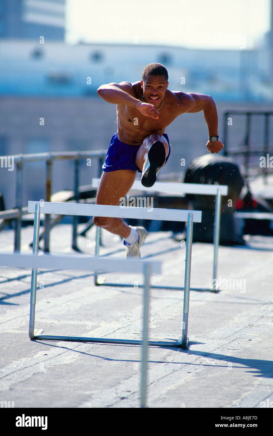 Runner jumping a hurdle hi-res stock photography and images - Alamy