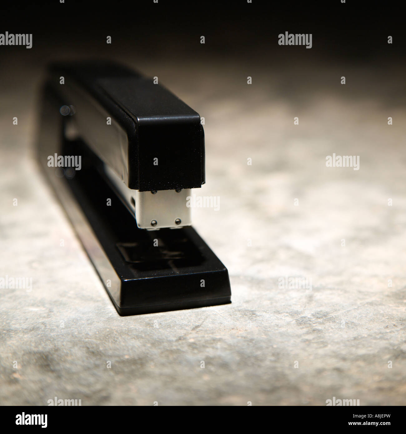 Black stapler on textured background Stock Photo - Alamy