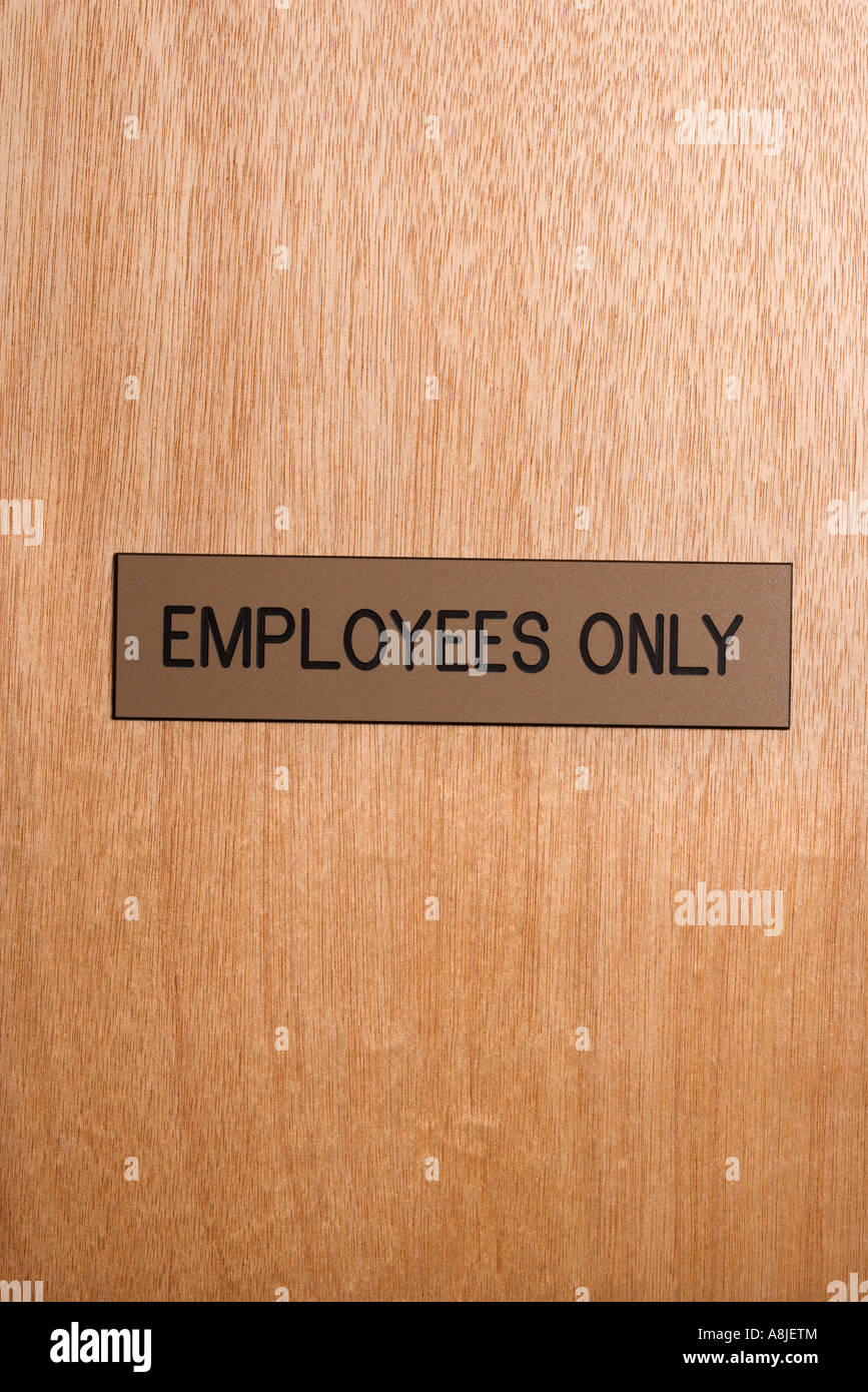 Employees only sign on wooden door Stock Photo - Alamy