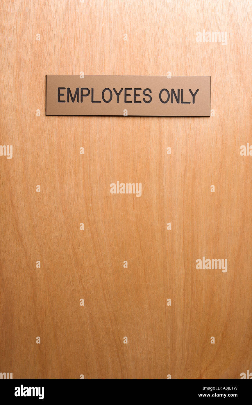 Employees only sign on wooden door Stock Photo - Alamy
