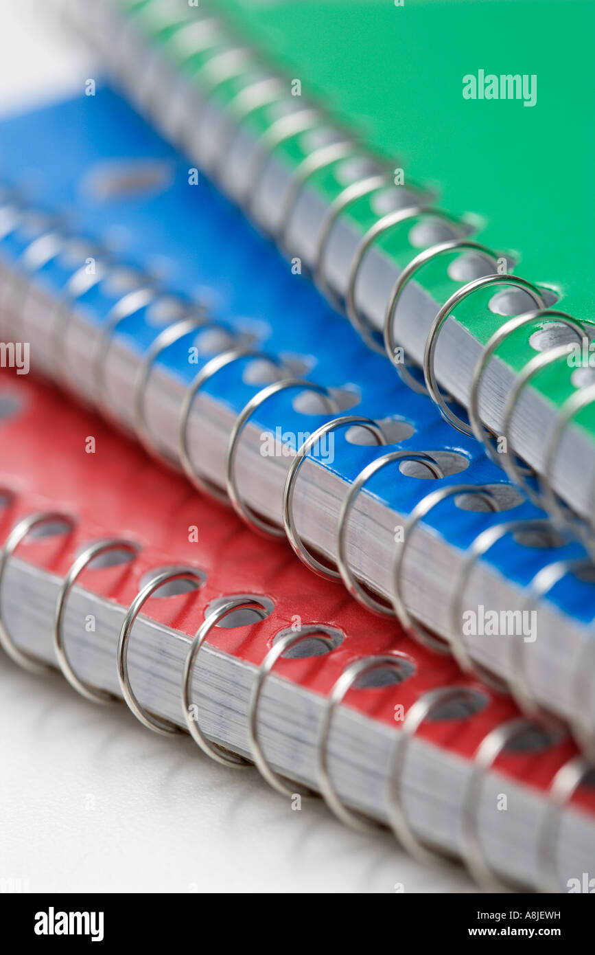 Close up of three spiral bound notebooks stacked up Stock Photo - Alamy