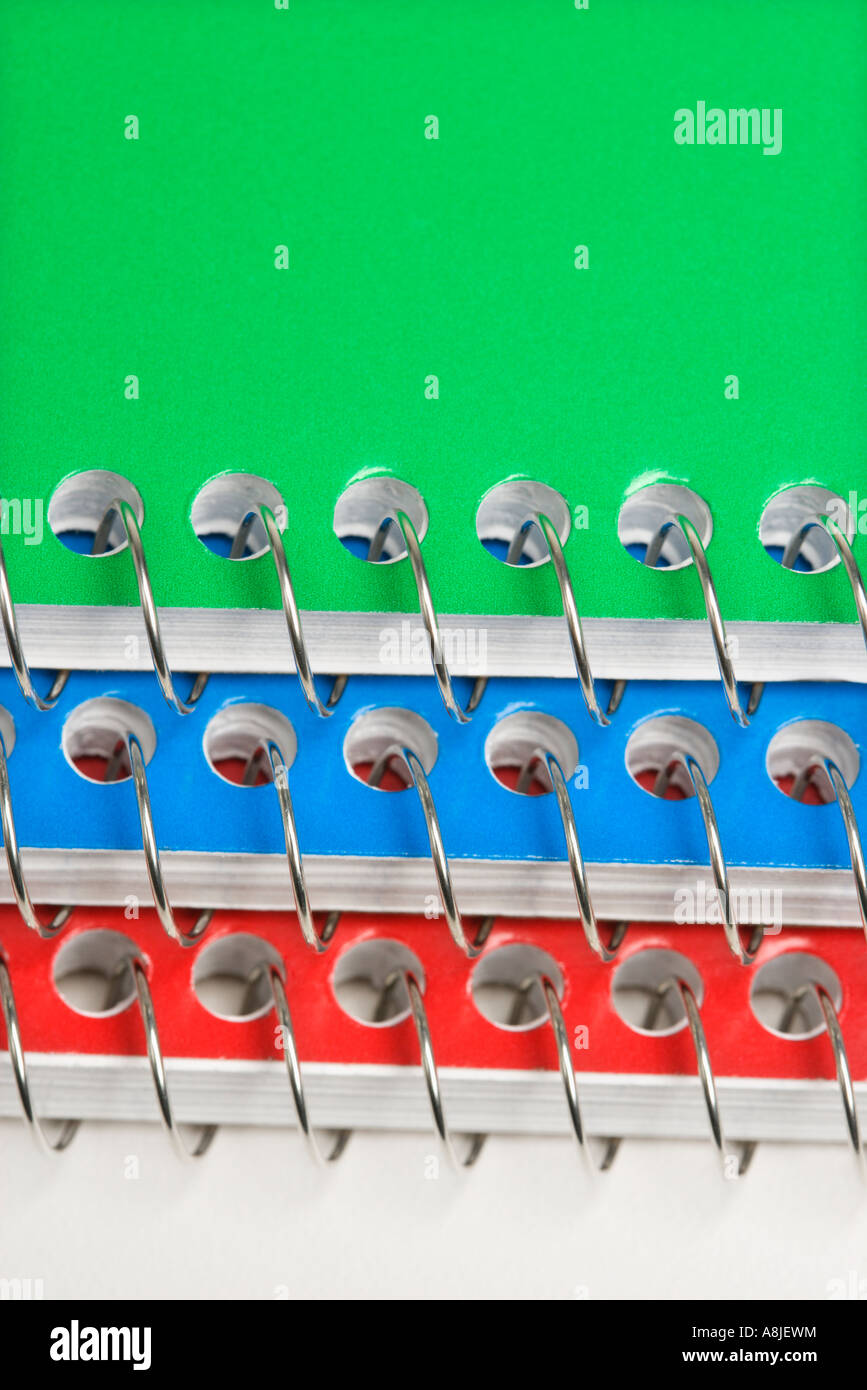 Close up of three spiral bound notebooks stacked up Stock Photo - Alamy