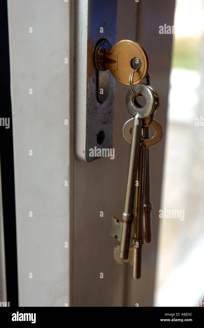 Keys in a door lock Stock Photo - Alamy