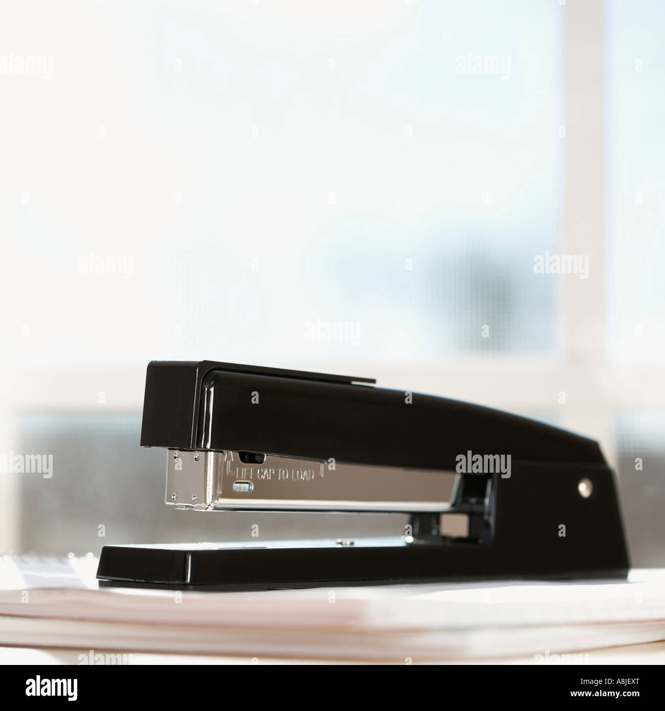 Black stapler with window in background Stock Photo - Alamy