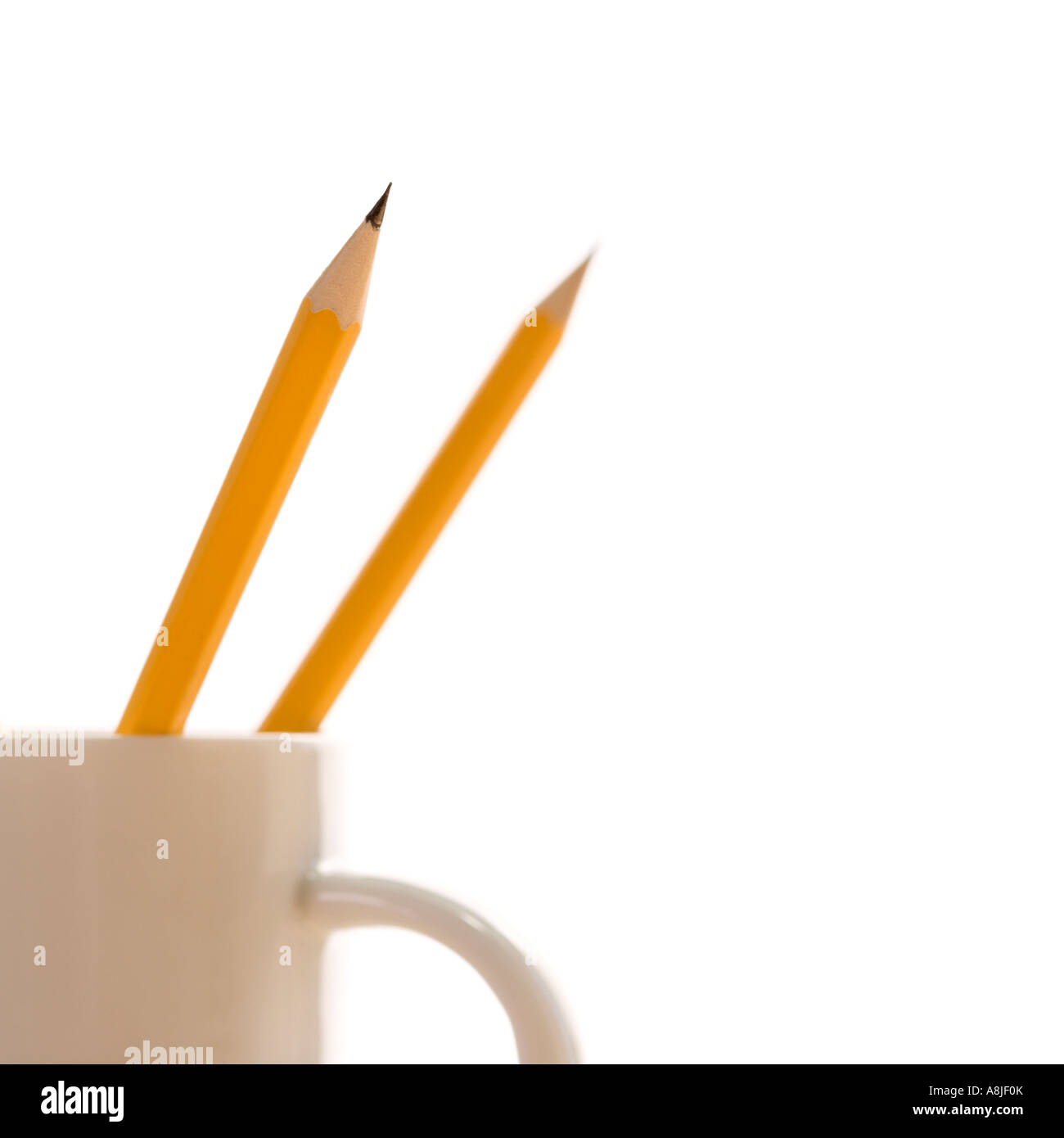 Two pencils in a coffee cup with pointed ends up Stock Photo - Alamy