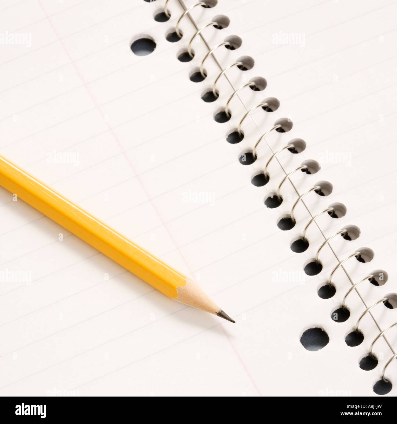 Sharp pencil placed on open spiral bound notebook Stock Photo - Alamy