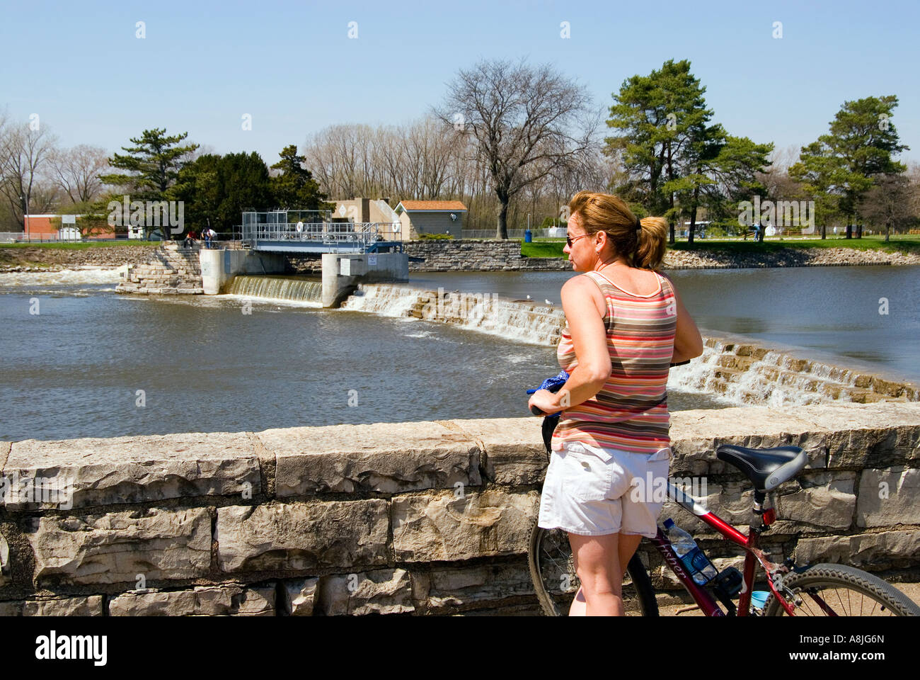 Girl & Bicycle at River Dam Stock Photo - Alamy