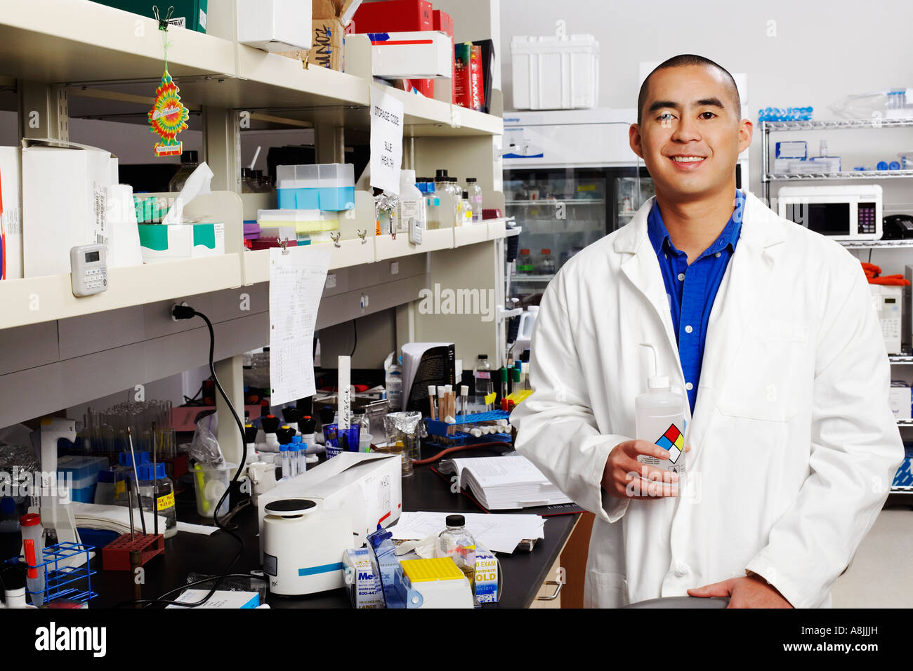 Portrait of a male pharmacist holding a bottle in a laboratory Stock ...