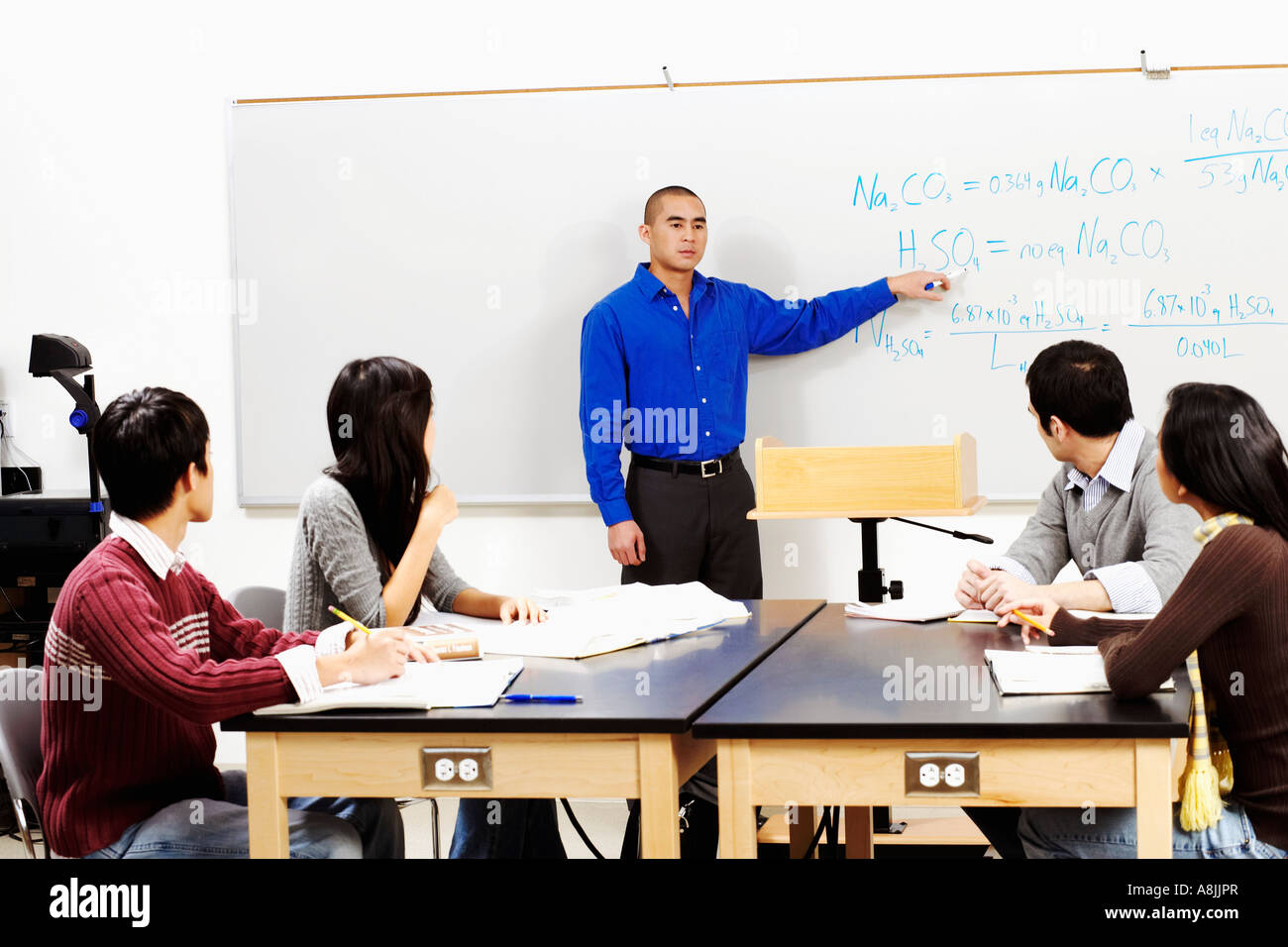 Professor teaching his students in a classroom Stock Photo - Alamy