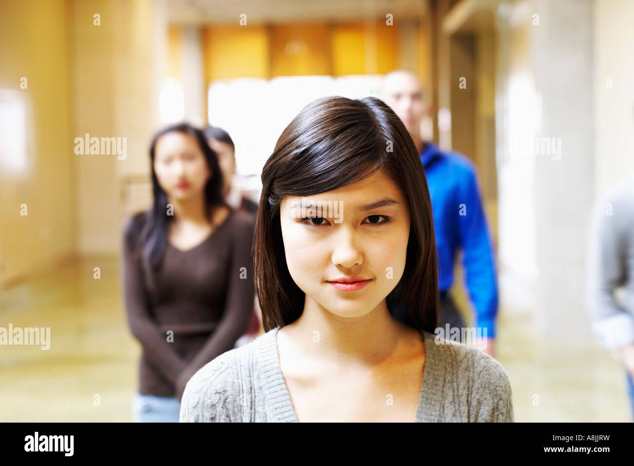 Portrait of a young woman walking in the corridor Stock Photo - Alamy