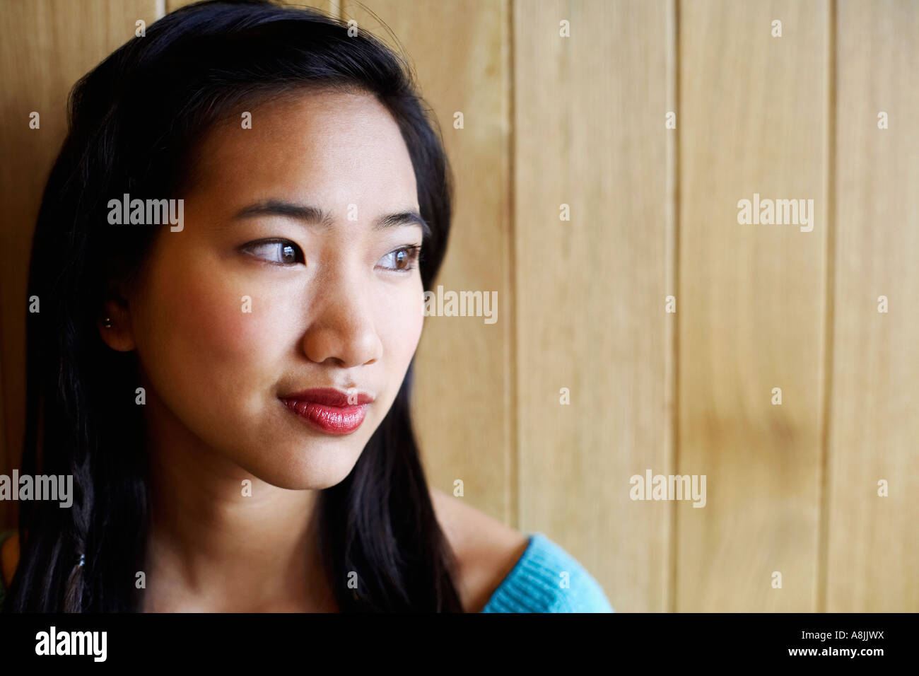 Close-up of a young woman grinning Stock Photo - Alamy
