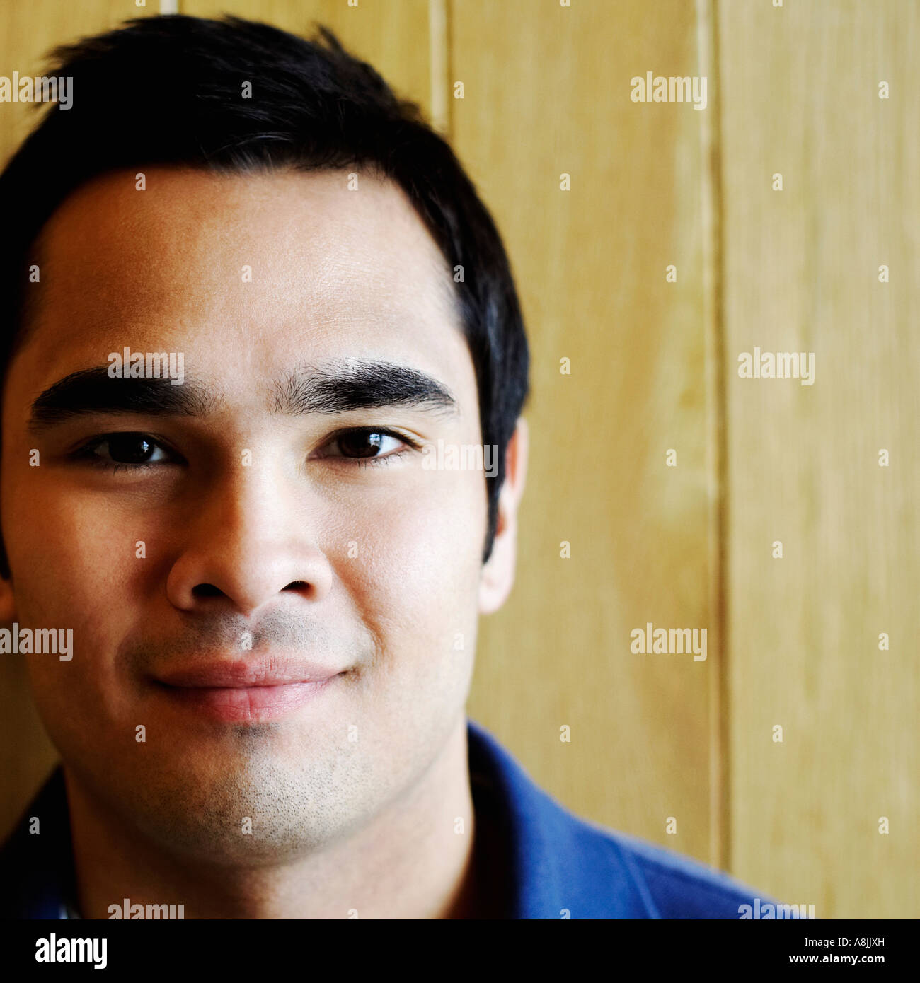 Portrait of a young man smirking Stock Photo - Alamy