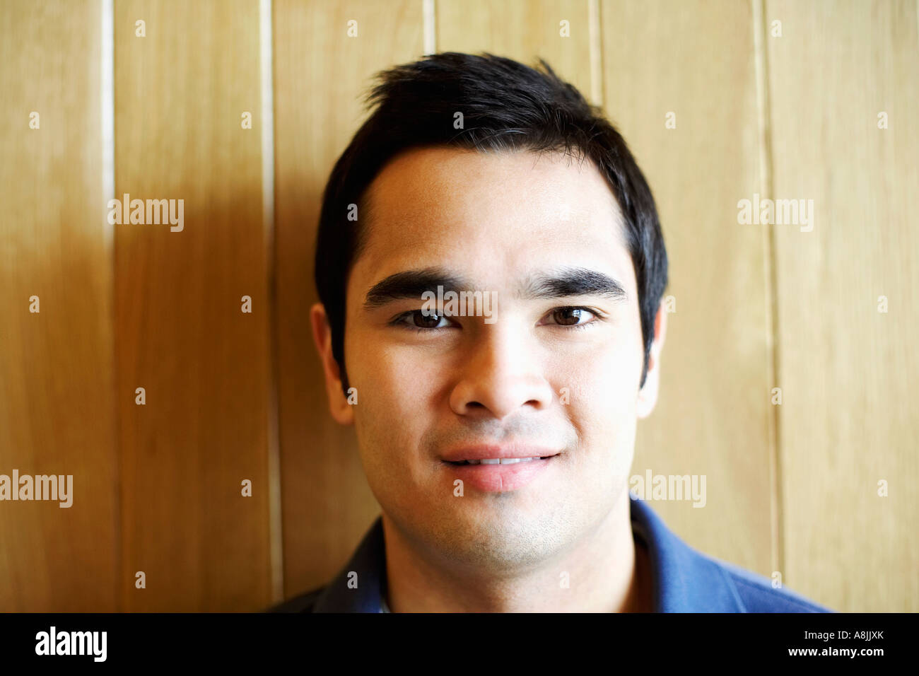 Portrait of a young man smirking Stock Photo - Alamy