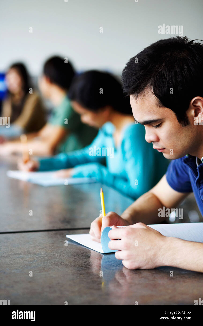 Side profile of a young man giving exams in a classroom Stock Photo - Alamy