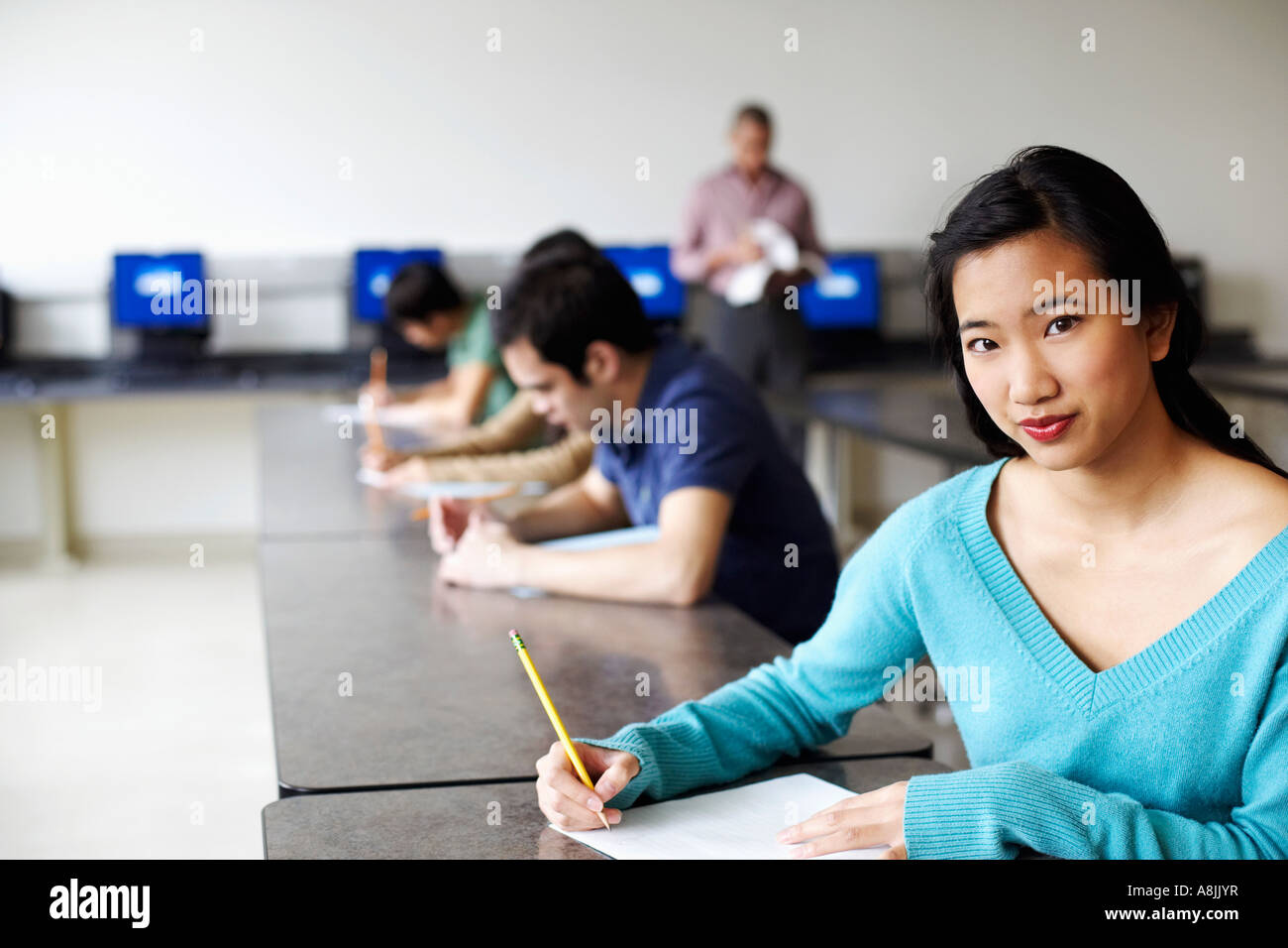 Portrait of a young woman giving exams in a classroom Stock Photo - Alamy