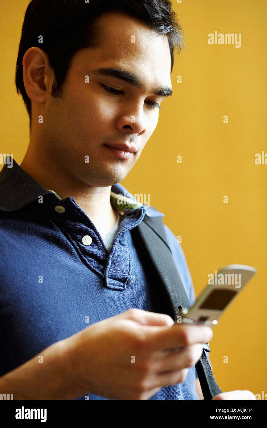 Close-up of a young man holding a mobile phone Stock Photo - Alamy