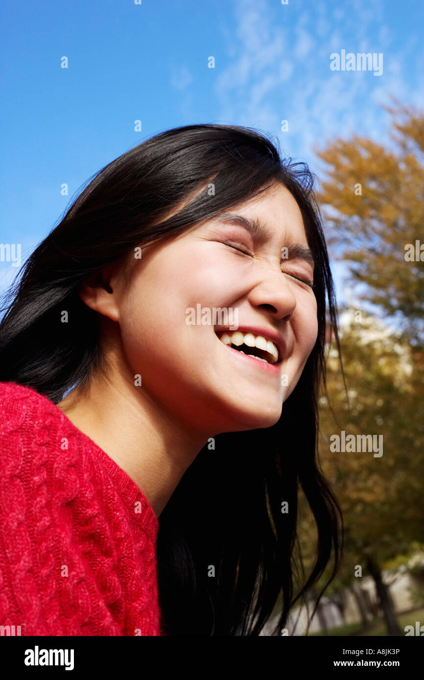 Side profile of a young woman smiling with her eyes closed Stock Photo ...