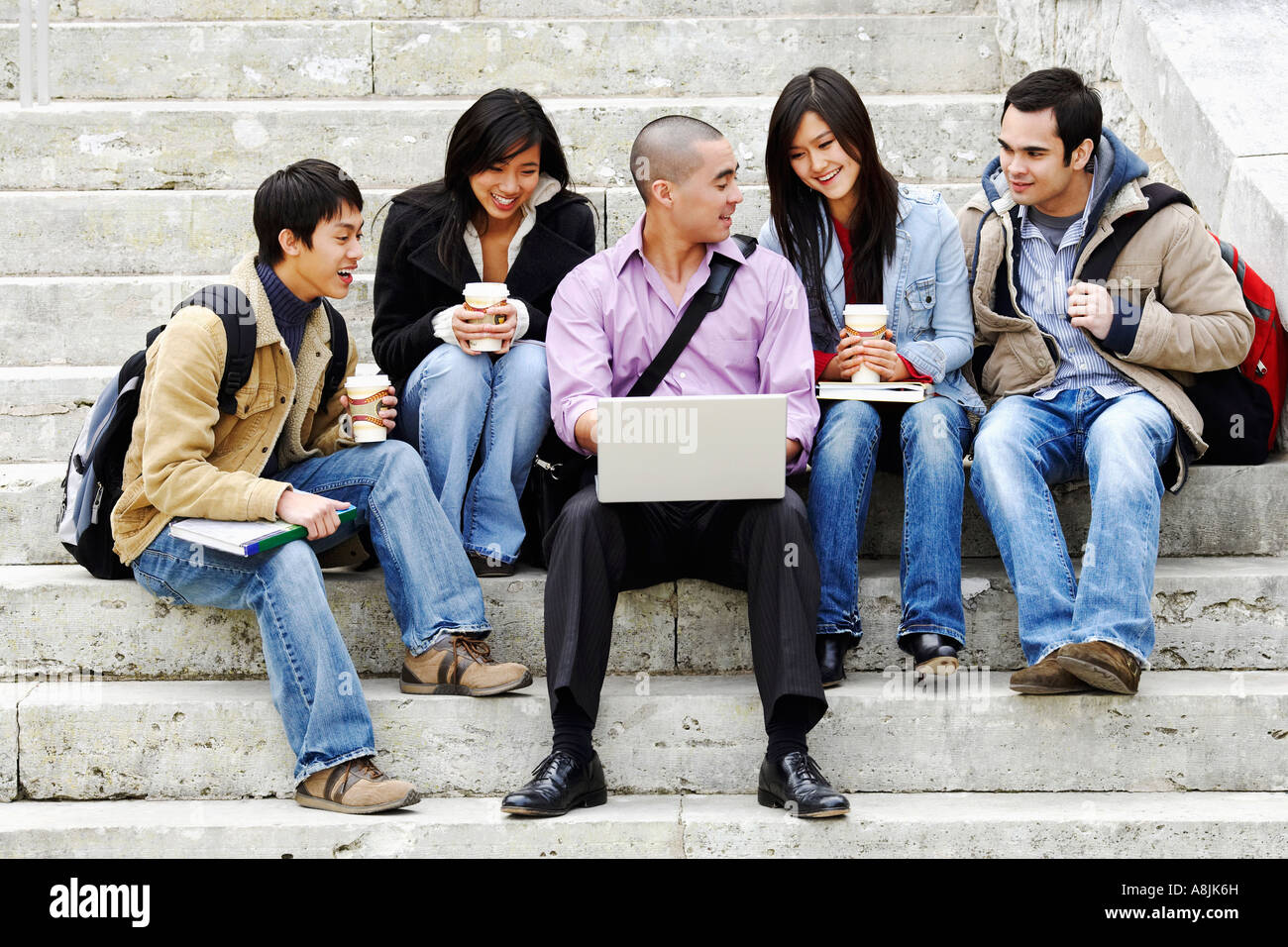 Five young college students sitting on steps and smiling Stock Photo ...