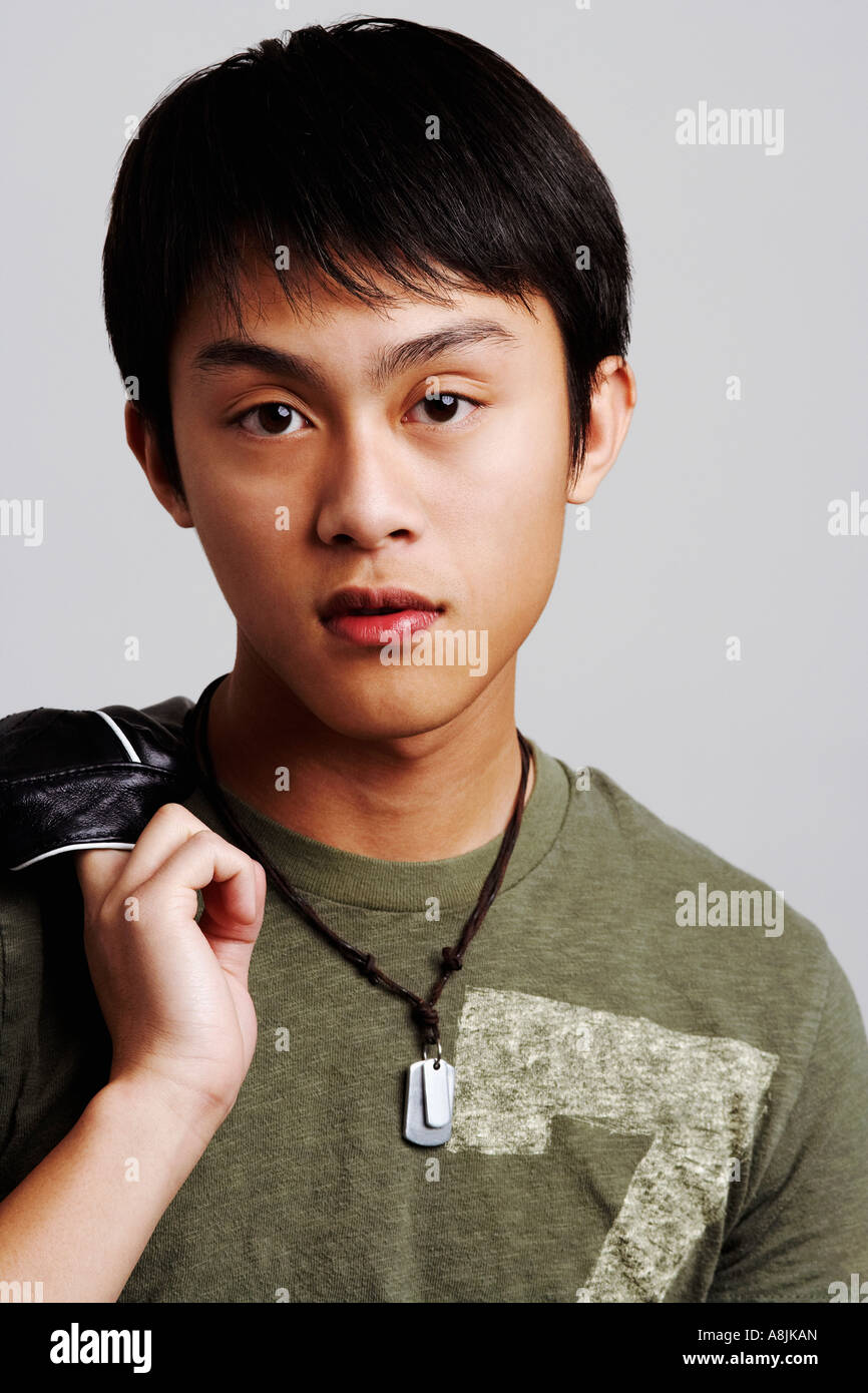 Portrait of a young man holding his jacket Stock Photo - Alamy