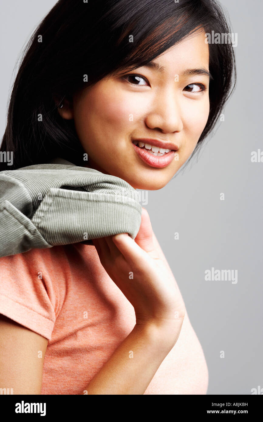 Portrait of a young woman holding a jacket Stock Photo - Alamy