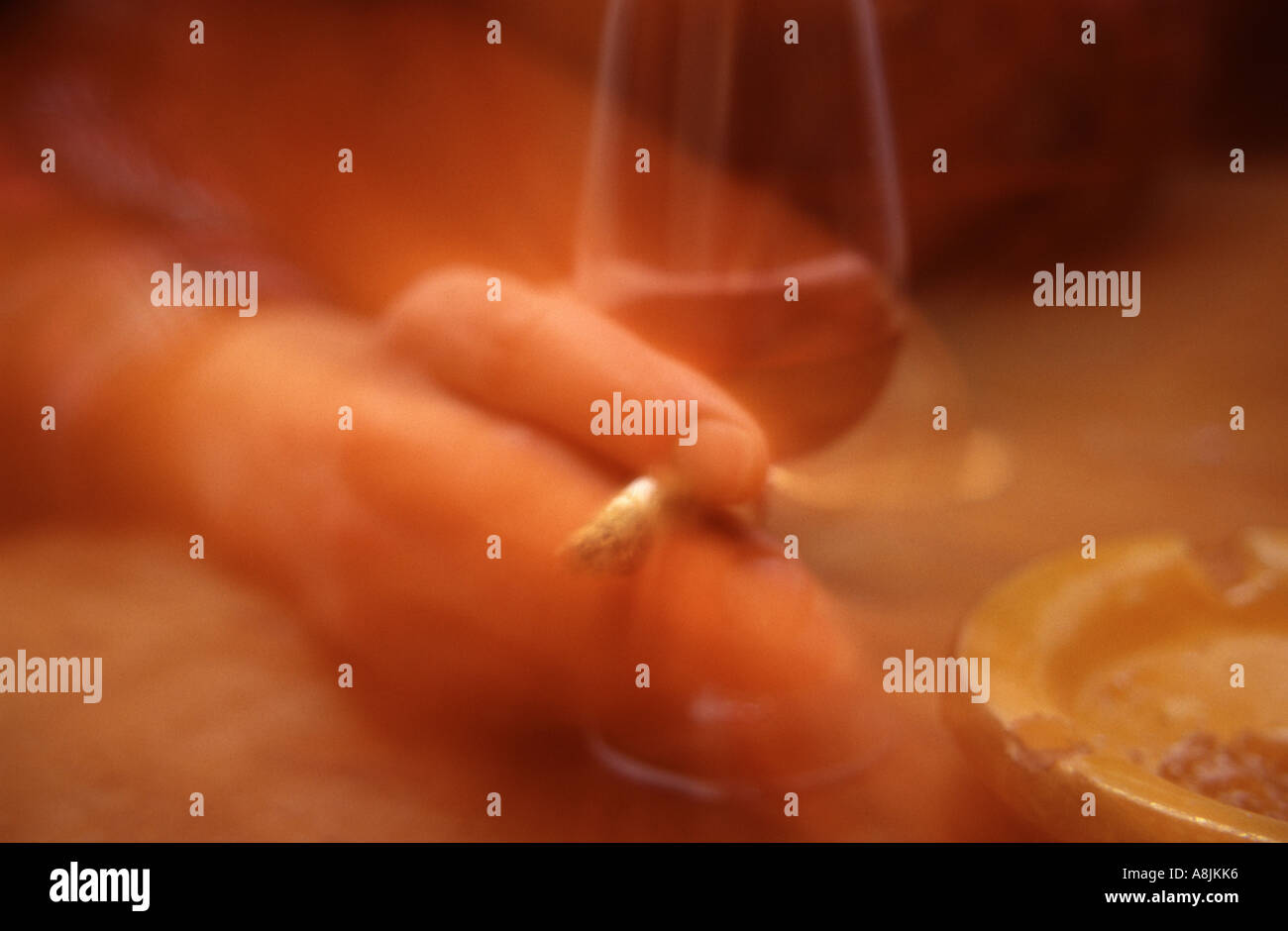 Abstract impressionist image of man smoking and drinking with ash tray ...