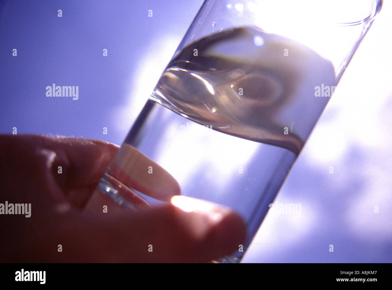hand holding glass containing water outdoors in sunshine Stock Photo ...