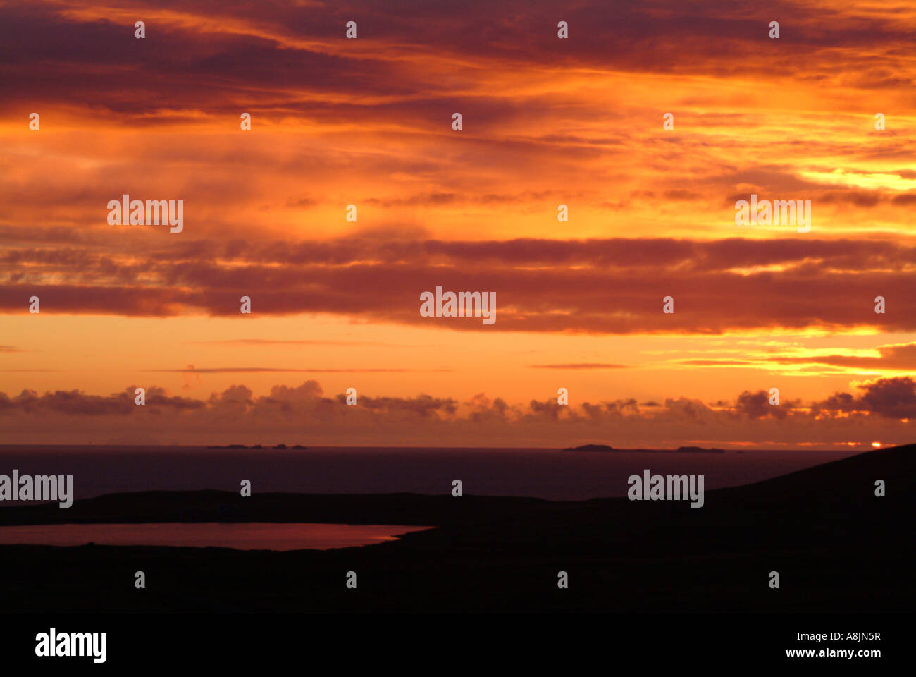 sunset from north uist st kilda just visible on horizon western isles ...