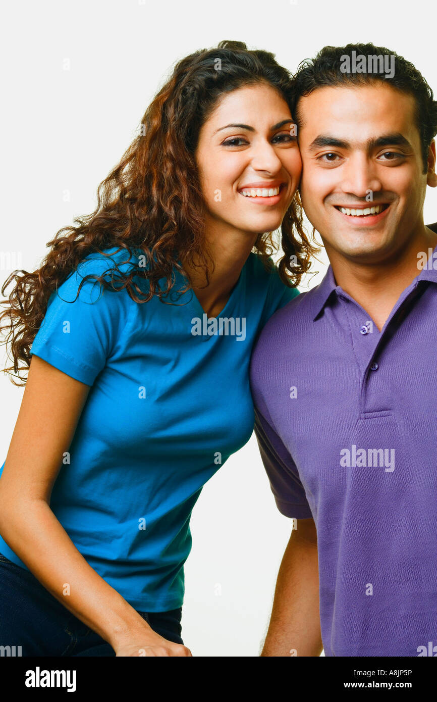 Portrait of a young couple smiling cheek to cheek Stock Photo - Alamy