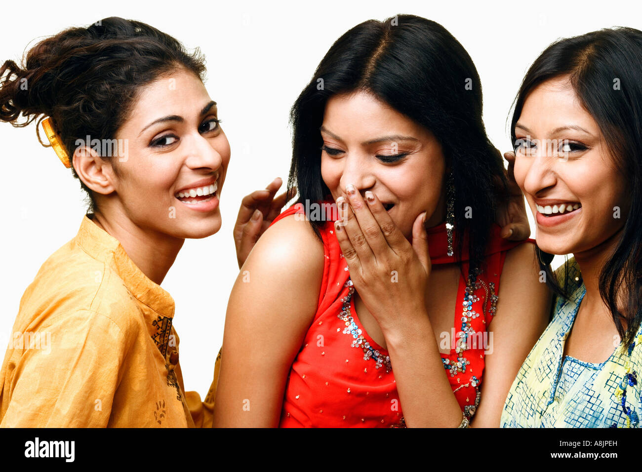 Close-up of three young women gossiping and smiling Stock Photo - Alamy