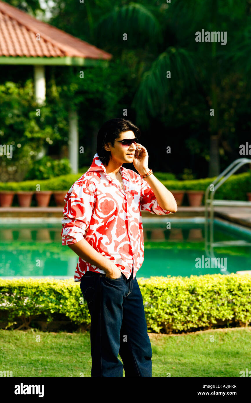 Side profile of a young man talking on a mobile phone Stock Photo - Alamy