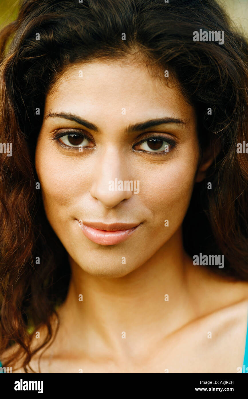Portrait of a young woman smirking Stock Photo - Alamy