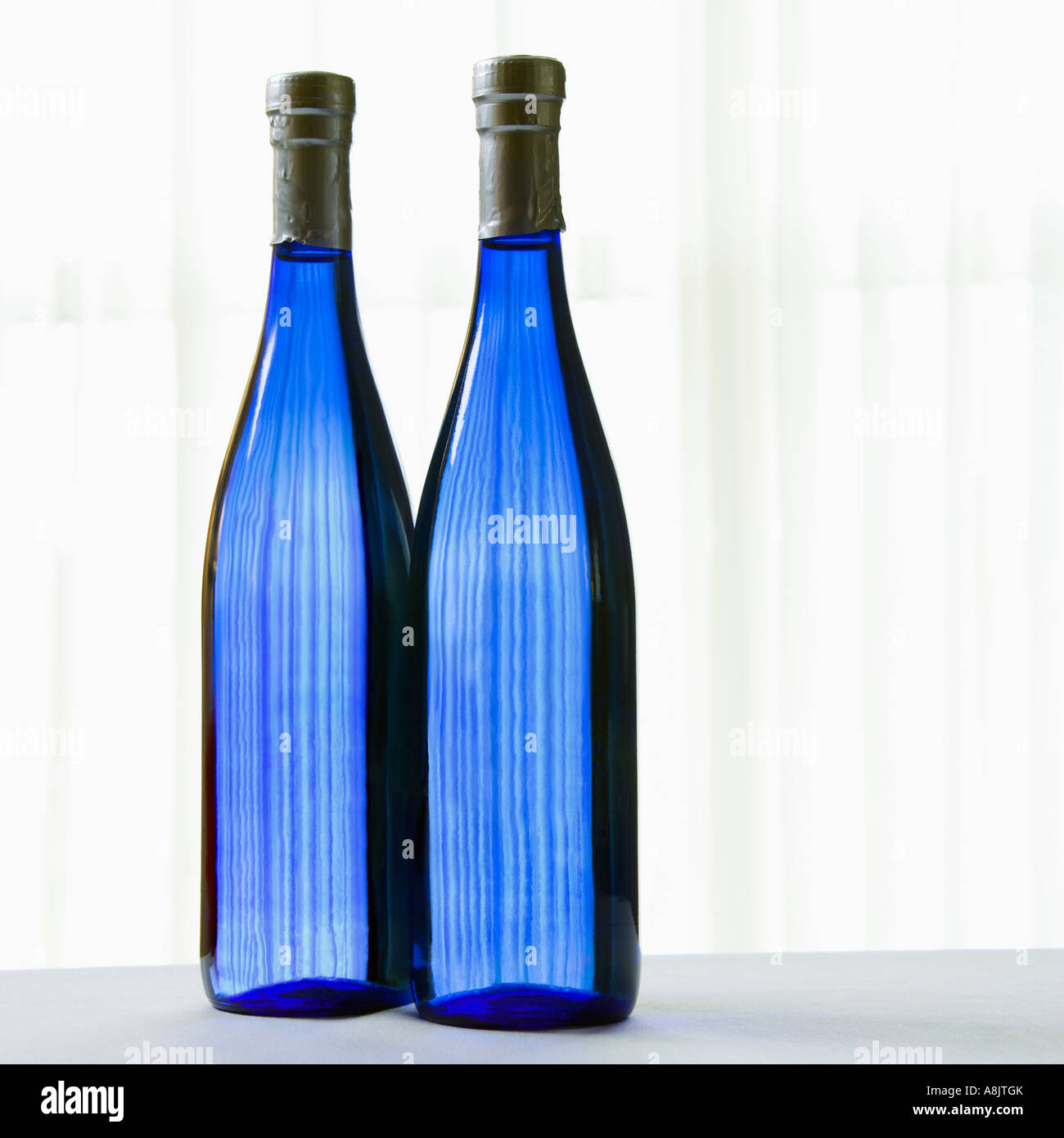 Two blue bottles with on white Stock Photo - Alamy