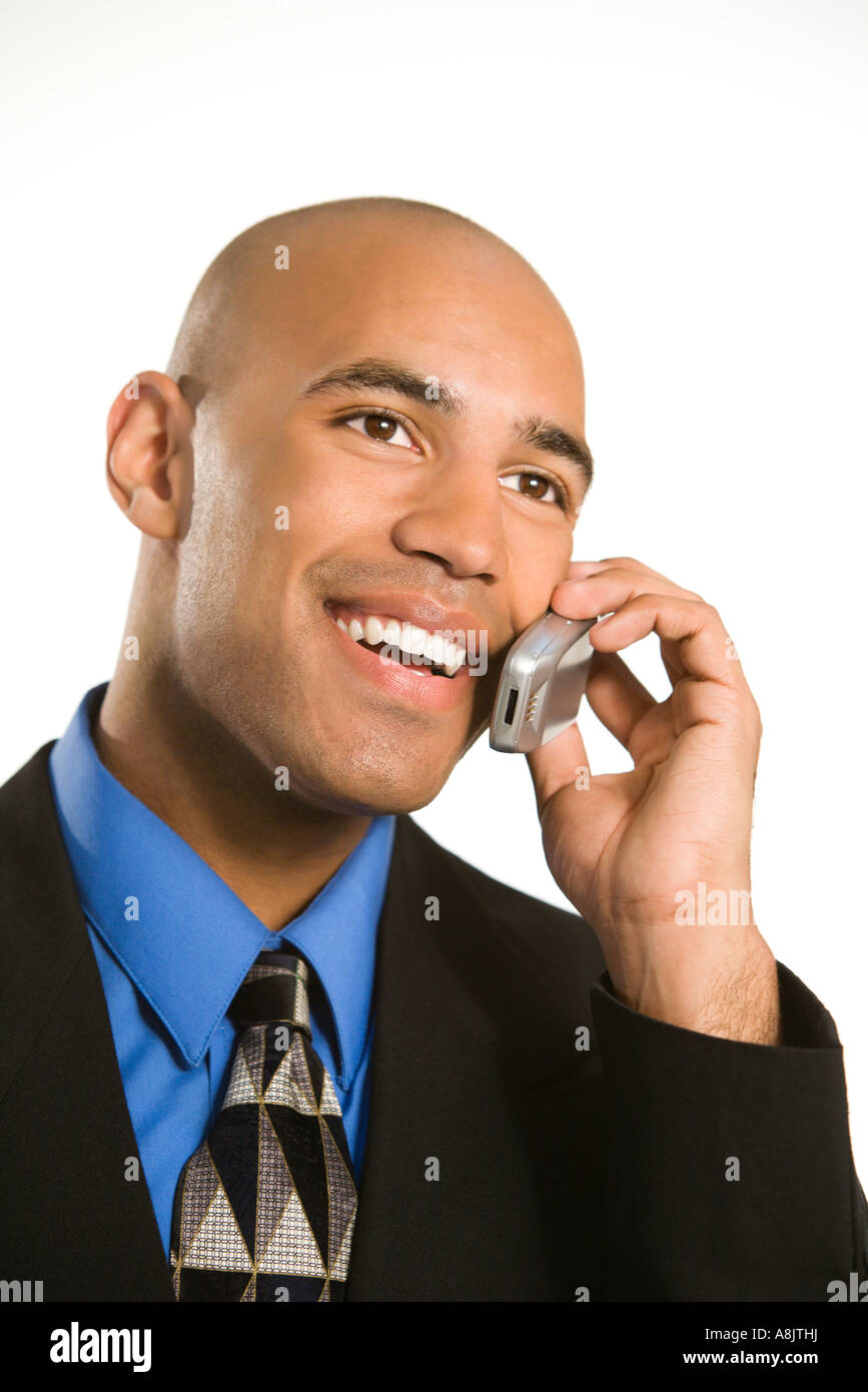 Head and shoulder portrait of African American man in suit talking on ...