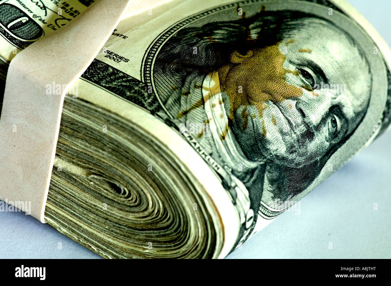 dirty, coffee stained abstract view of folded stack of one dollar bills ...