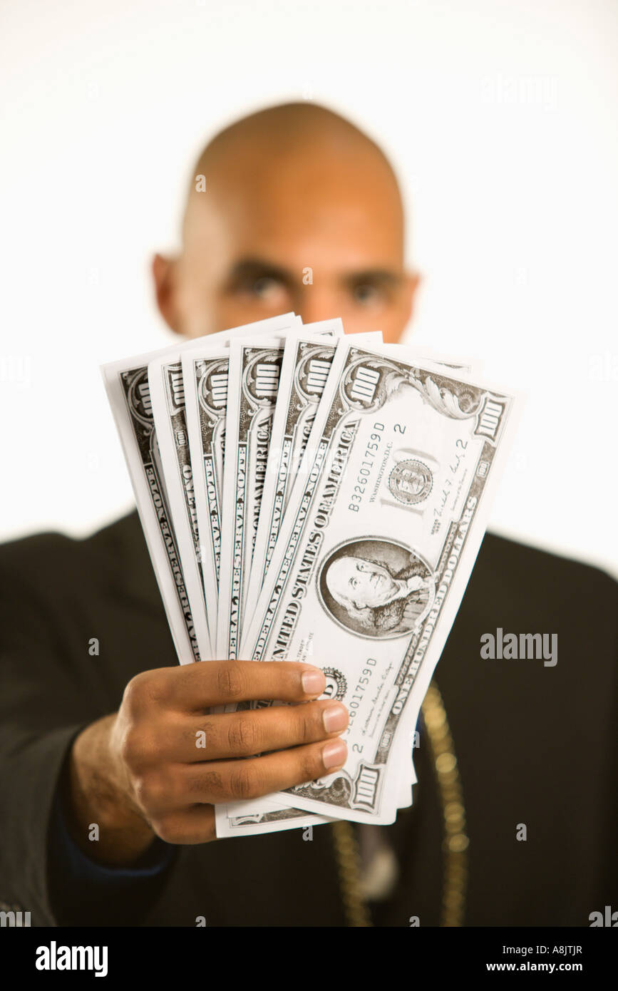 African American man in suit holding cash Stock Photo - Alamy