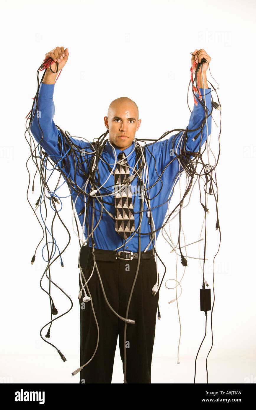 African American businessman wrapped in computer cables Stock Photo - Alamy
