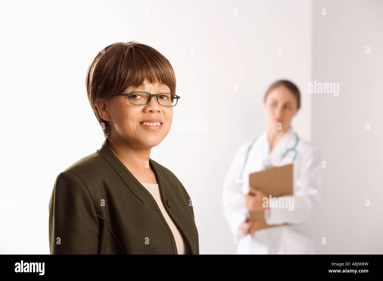 Patient with doctor in the background Stock Photo - Alamy