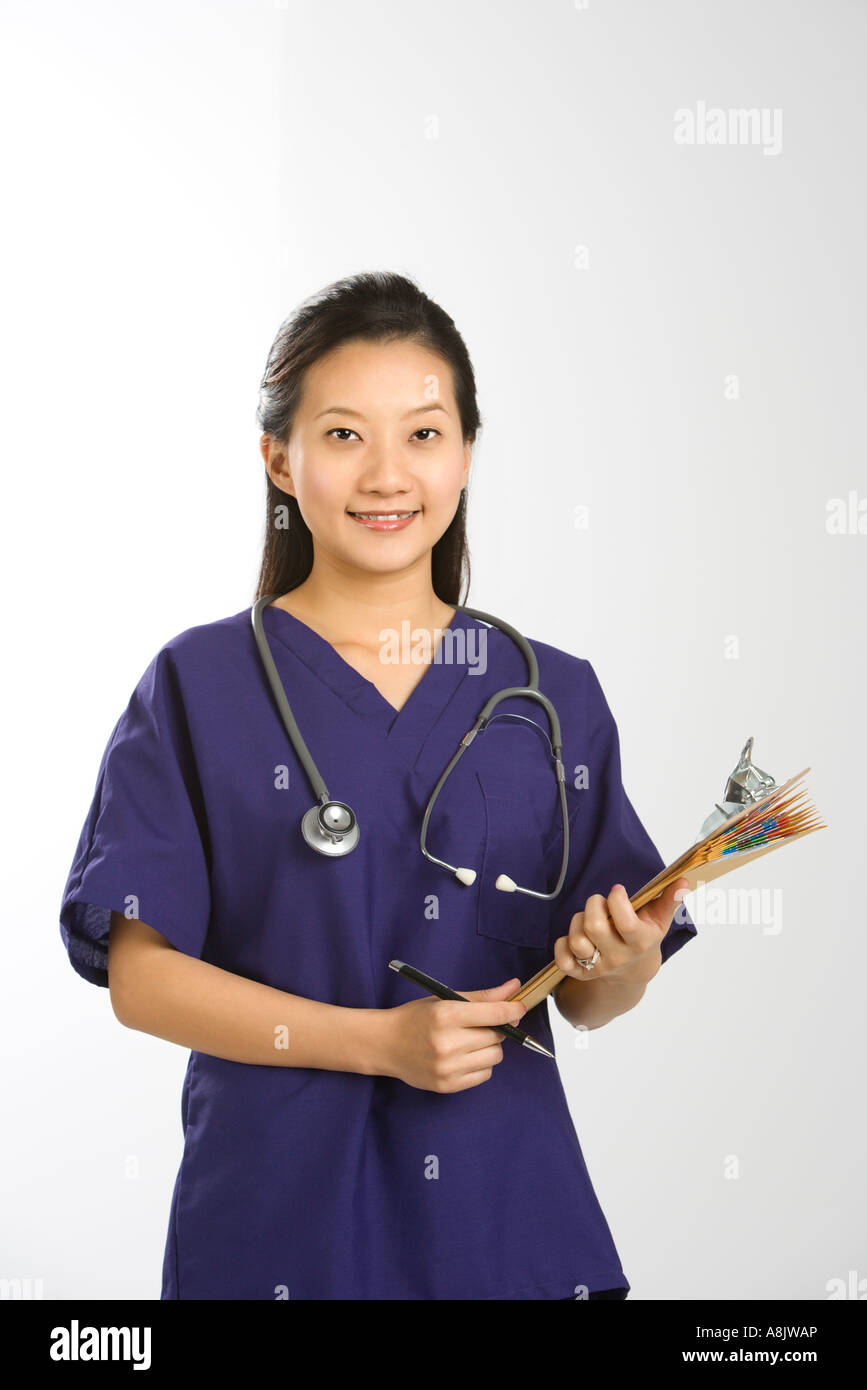 Portrait of Asian Chinese mid adult female doctor smiling and looking ...